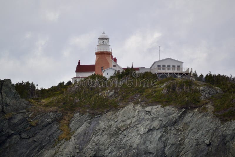 Long Point Lighthouse at the Top of Cliff in Twillingate Harbour Stock ...