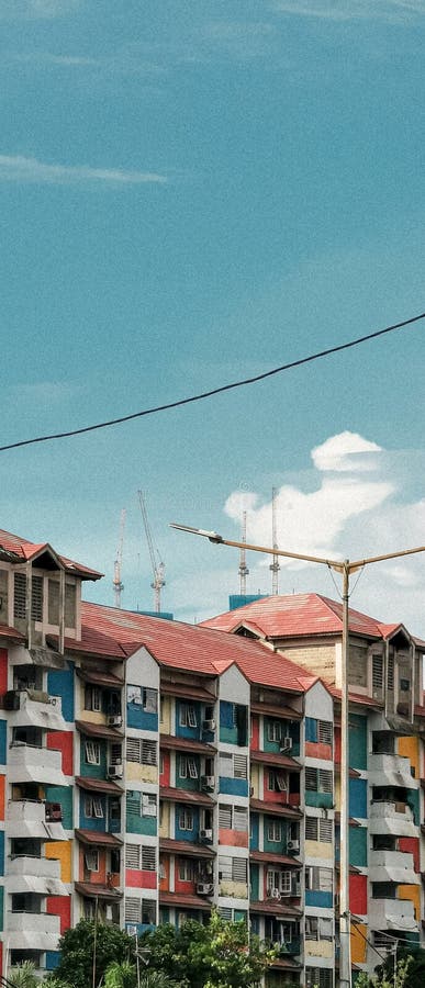 Long Potrait of Residential Building with Warm Tones and Beautiful Sky ...