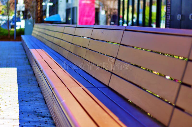 A Long Public Timber Bench in a Park. Stock Image - Image of timber ...