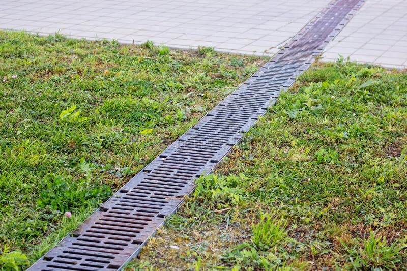 Long Rain Drain on Grass and Pavement Stock Image - Image of rain ...