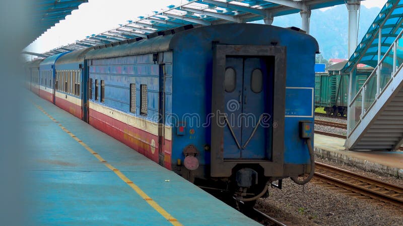 Long Red and Blue Outbound Express Train Leaves the Empty Platform in ...