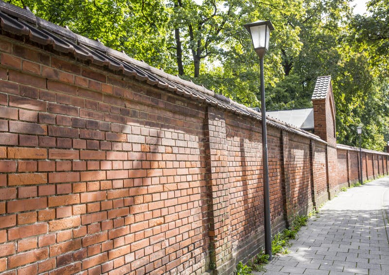 Long red bricks wall stock image. Image of property - 288947811