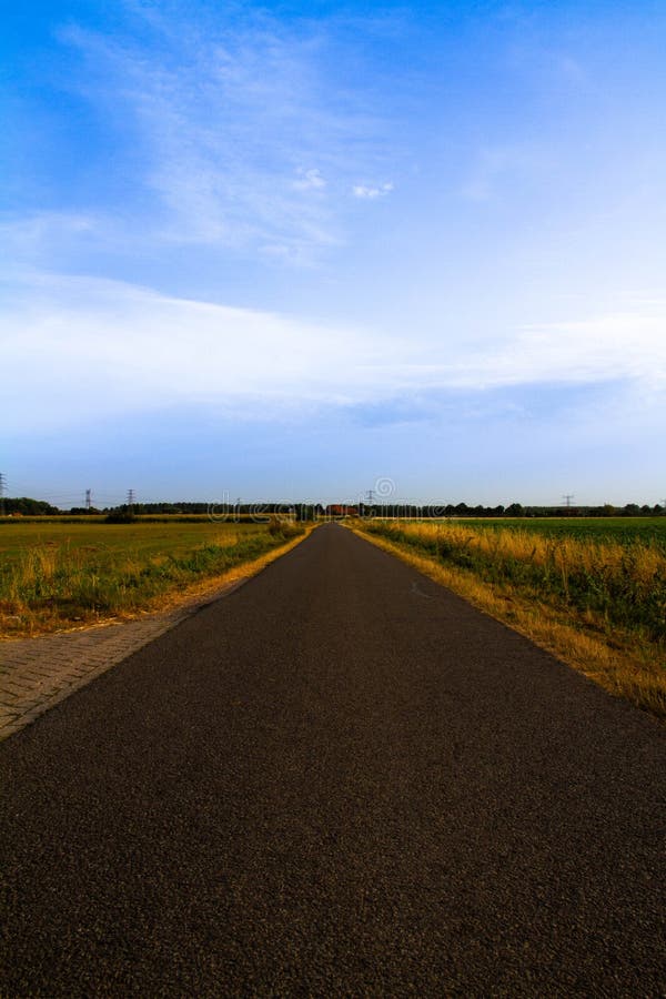 Long road with a black sky stock photo. Image of netherlands - 123256002