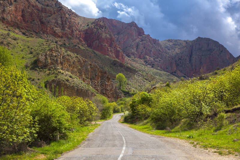 A Long Road with Hight Rock and Green Trees Stock Photo - Image of ...