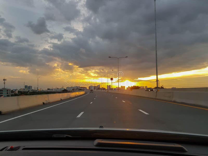 The long road with sunset stock photo. Image of scene - 141248052