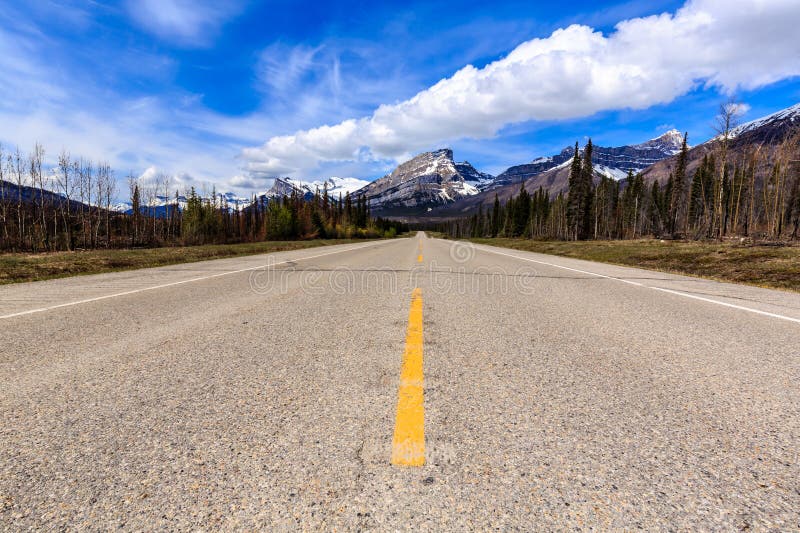 A Long Road with a Yellow Line Down the Middle Stock Image - Image of ...