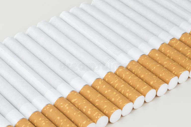 Long Row of Cigarettes with Orange Filter Tips Stock Image - Image of ...