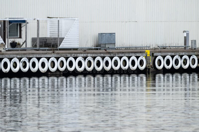 Long Row of White Painted Tyres on a Pier.. Stock Photo - Image of ...