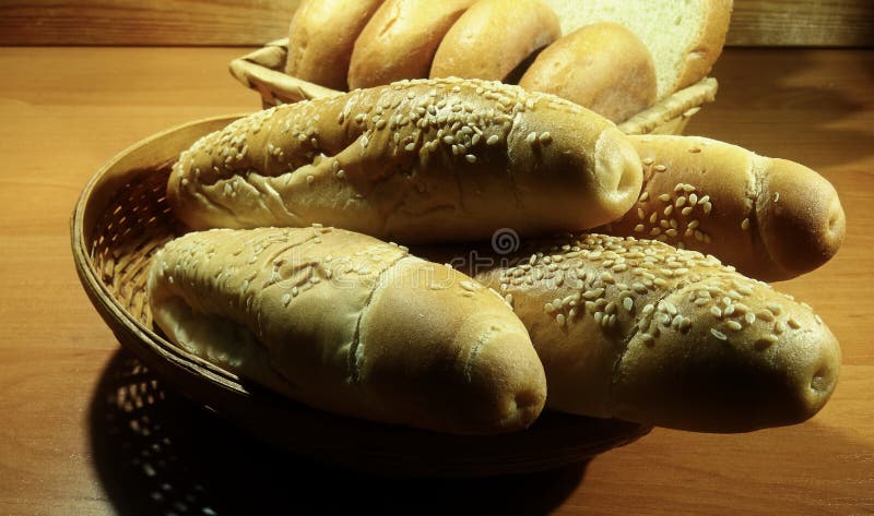 Long Sesame Buns, Round Rolls and Sliced Bread in Wicker Basket Stock ...