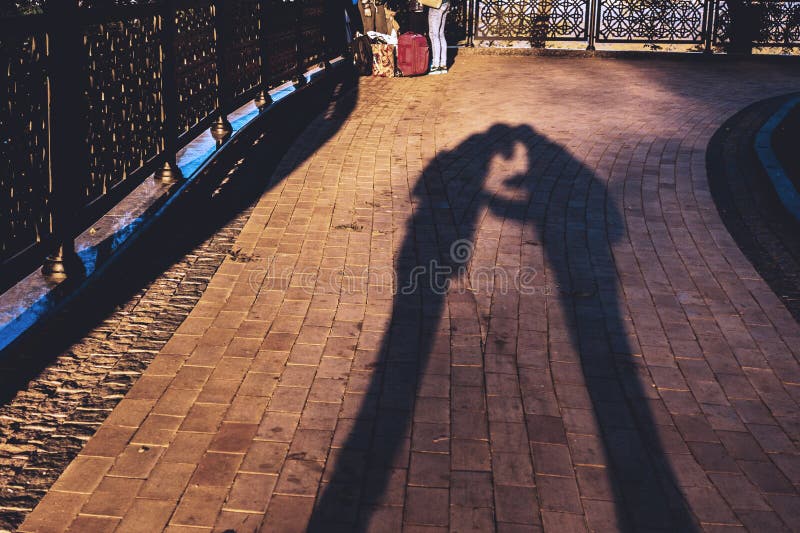 Long Shadow of a Couple on the Pavement Facing Each Other Stock Image ...