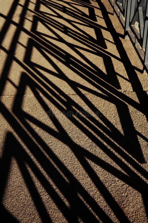 Long Shadows from a Railing Form the Unique Pattern on a Textured ...