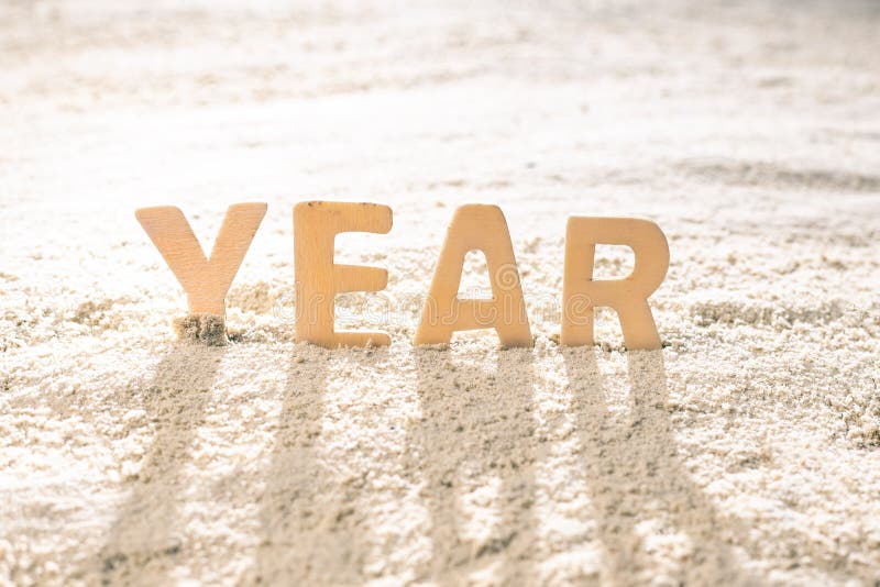 Long Shadows from the Word Year Stuck in the Sand. Long Shadows on the ...