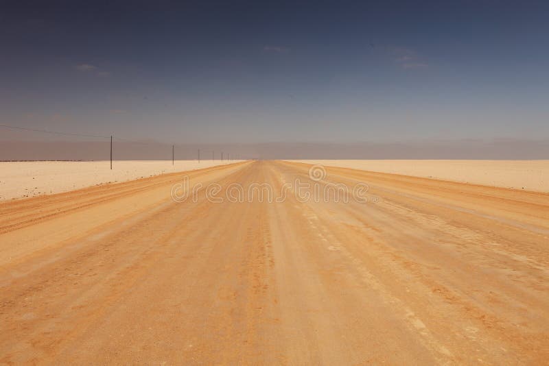 Long Shot of a Desert Sand Highway with Power Lines at the Side Stock ...
