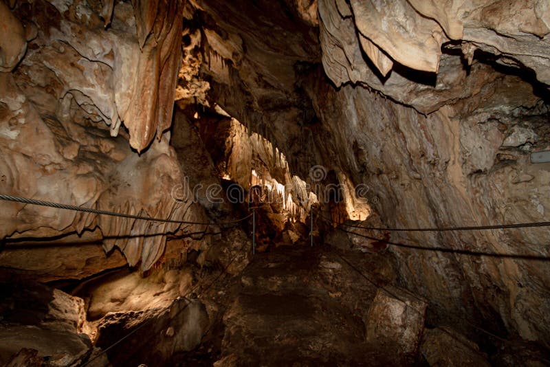 Long Shot of the Inside of a Cave with Low Ceiling and a Path Set with ...