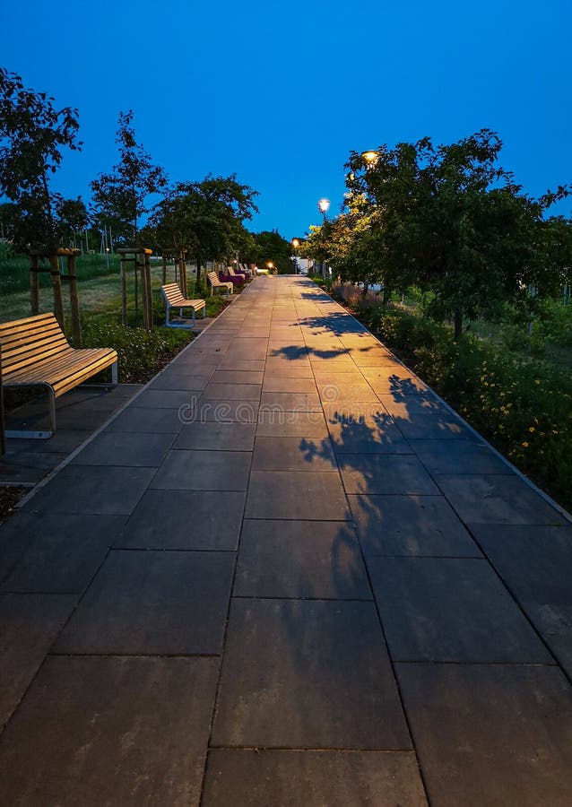 Long Sidewalk Path with Concrete Tiles between Lanterns Stock Photo ...