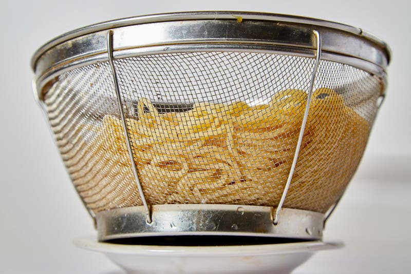 Long Spaghetti in an Iron Colander on a White Background Stock Image ...