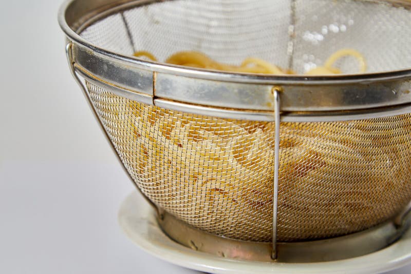 Long Spaghetti in an Iron Colander on a White Background Stock Image ...