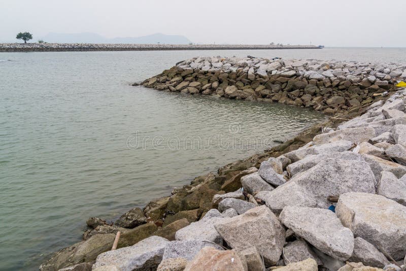 Stone Seawall Toward Empty Pier Stock Photo - Image of wave, coastline ...