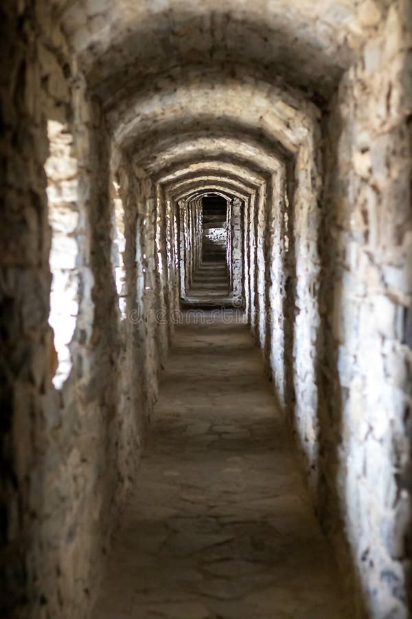A Long Stone Tunnel Corridor with Windows in an Old Castle. Selective ...
