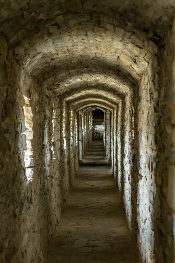 A Long Stone Tunnel Corridor with Windows in an Old Castle. Selective ...