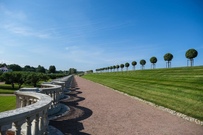 A Long Stone Walkway with a Row of Trees on Either Side Stock Photo ...