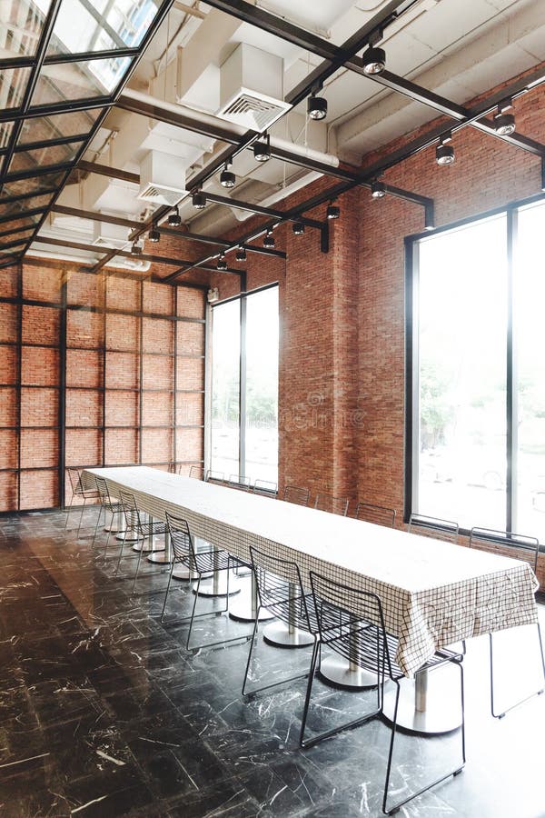 Long Table with Black Steel Chairs Inside Brick Wall Room Decorated in ...