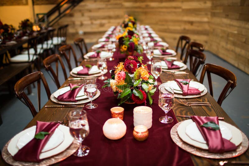 Long Table Covered with Dark Red Texture and Plates with Splayds Stock ...