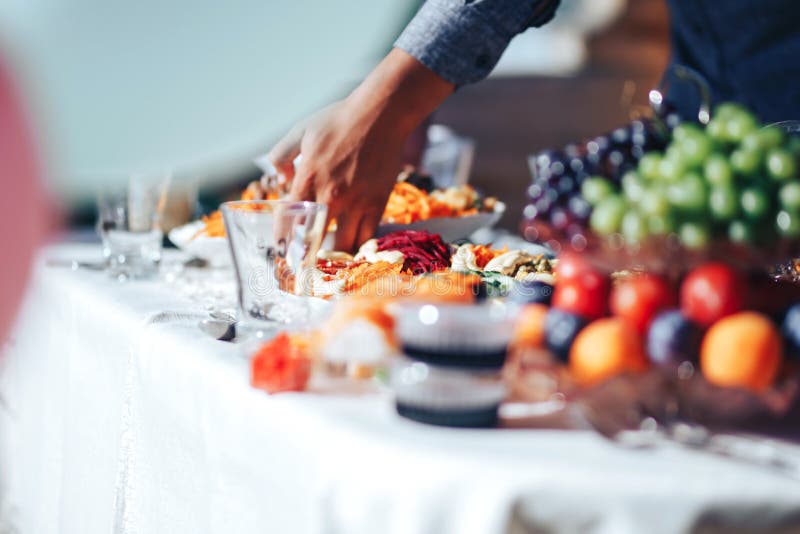Long Table Covered with a Tablecloth on Which There is a Lot of Food ...