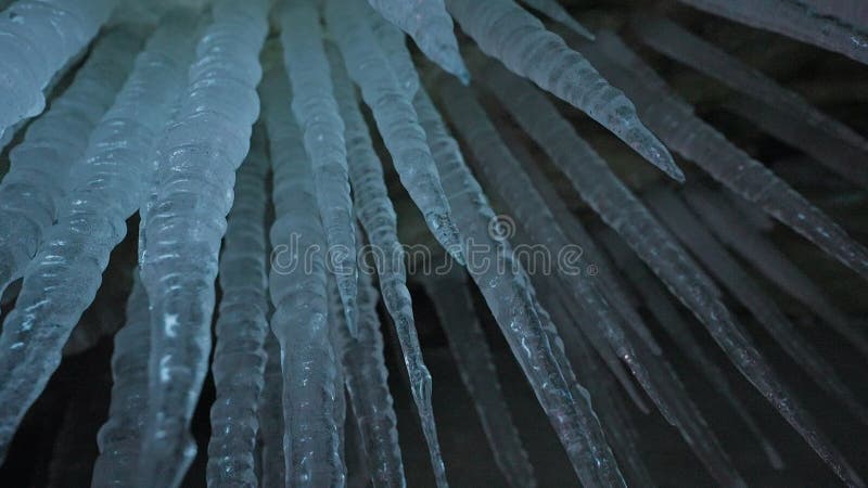 Long Tapering White Icicles with Sharp Edges Hang on Ceiling Inside Ice ...