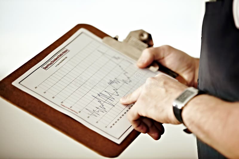 Long-term Market Tracking. a Person Pointing at a Graph on a Clipboard ...