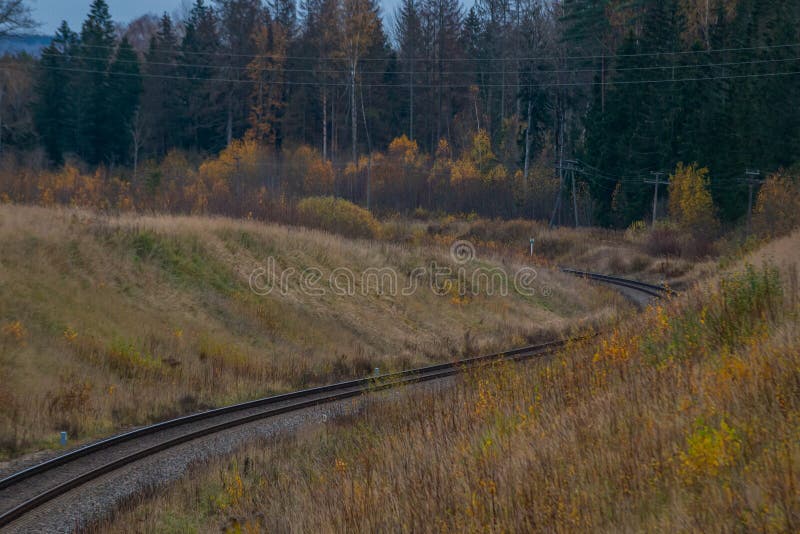 Long Train Tracks Going through Autumn Hills and a Forest Stock Photo ...