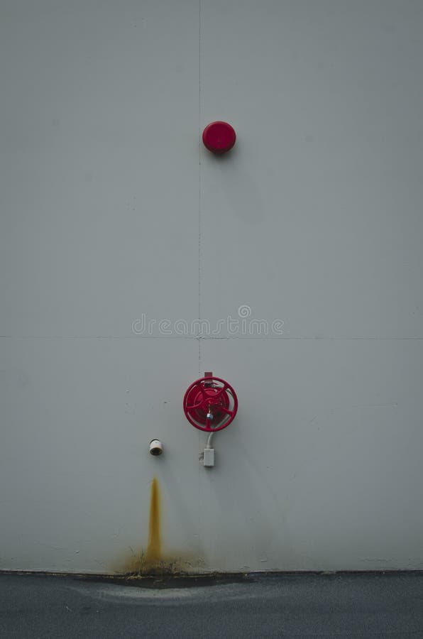 A Long View of the Red Fire Bell on the White Wall Stock Image - Image ...