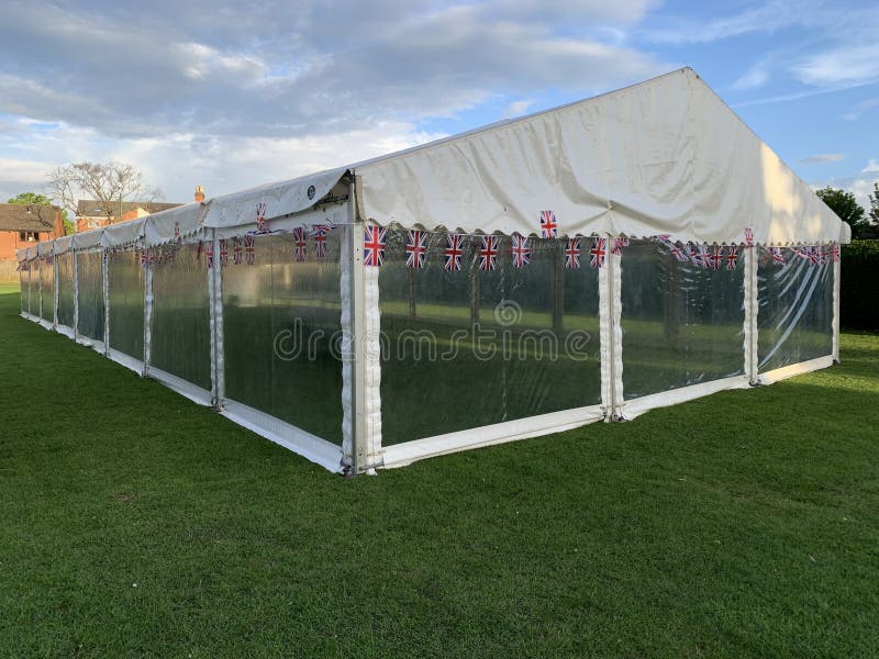 Long White Empty Tent in a Public Park with Rectangular Union Jack ...