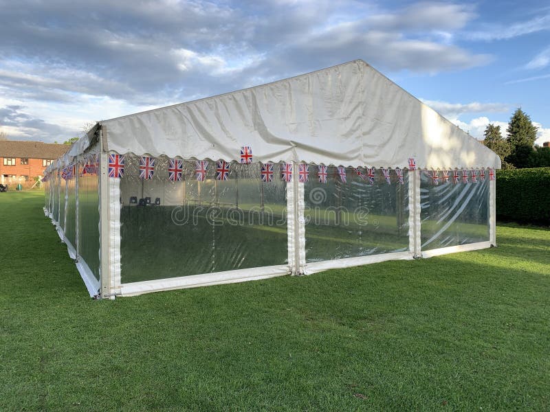Long White Empty Tent in a Public Park with Rectangular Union Jack ...