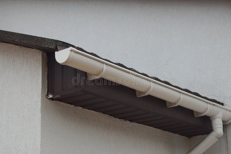 Long White Plastic Gutter Pipe on Brown Gray Wall Stock Photo - Image ...