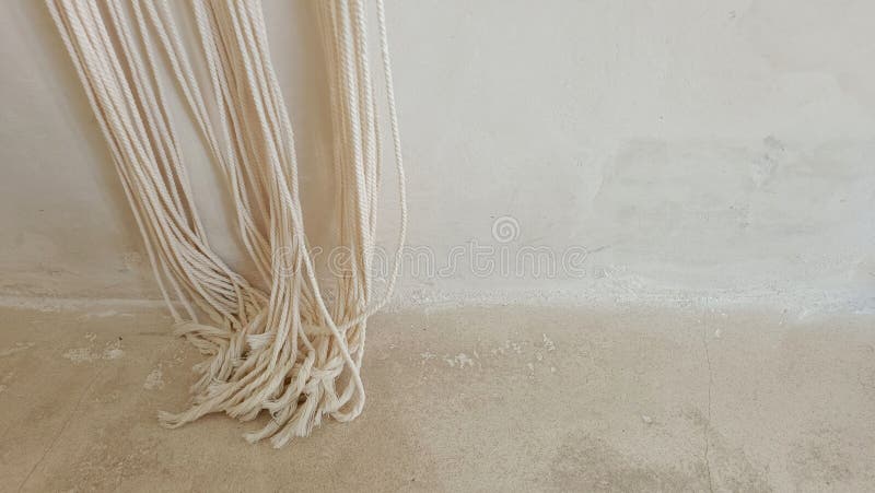 A Long White Rope is Hanging from the Wall Stock Photo - Image of brown ...