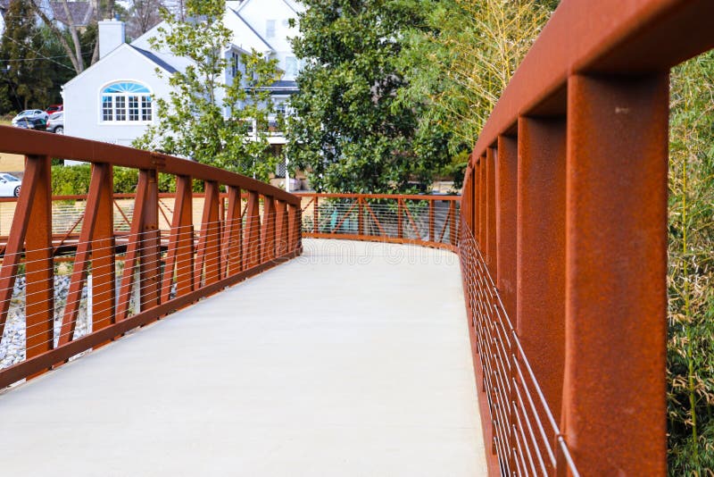 A Long Winding Smooth Paved Rust Colored Bridge Surrounded by Lush ...