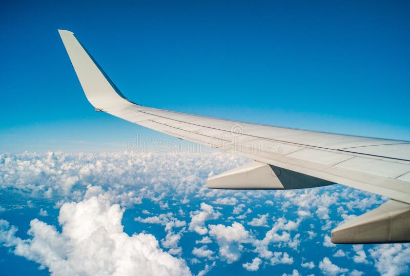 Long Wing of the Airplane in the Blue Cloudy Sky Stock Photo - Image of ...