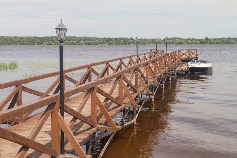 A Long Wooden Bridge, the Pier Goes Far into the River Stock Photo ...