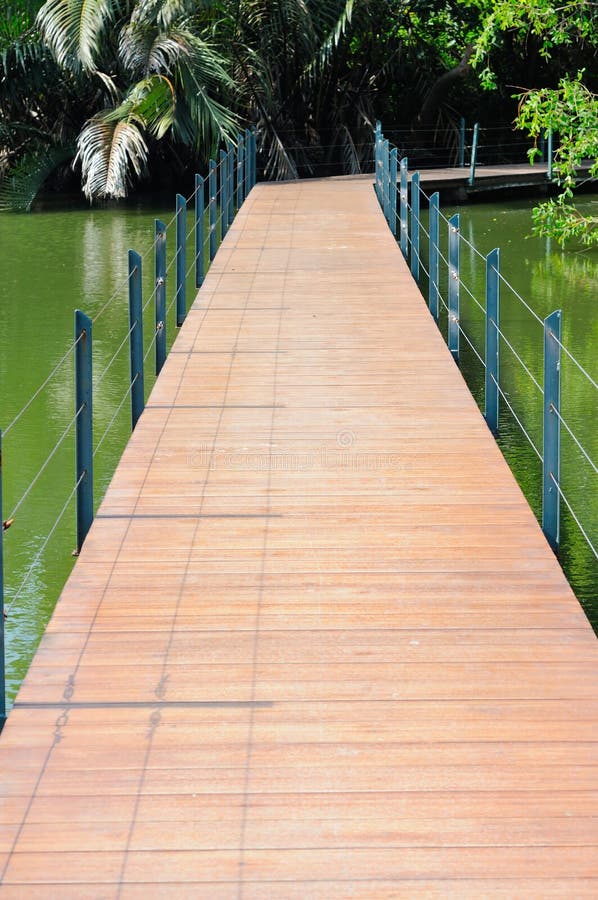 A Long Wooden Foot Bridge in a Park Stock Photo - Image of morning ...