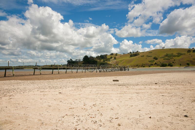 Long Wooden Pier Over Tidal Beach Stock Photo - Image of zealand ...