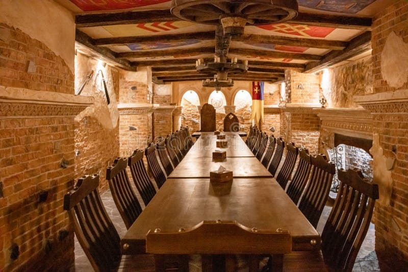 A Long Wooden Table with Many Chairs and a Flag on the Wall Editorial ...