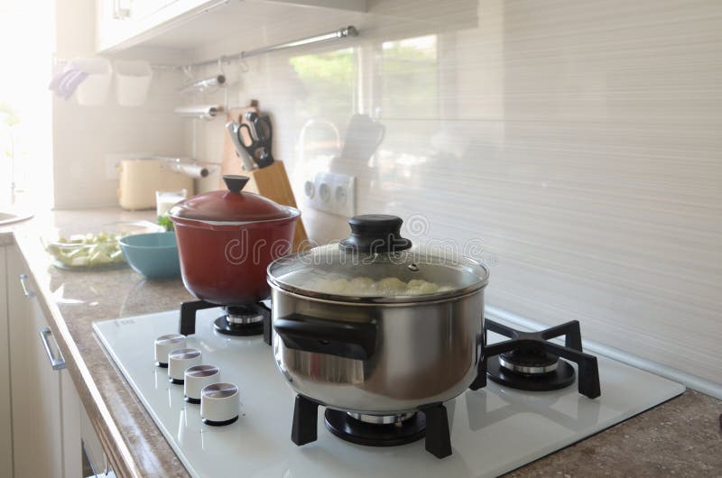 Cooking in a Pots on the Hob in the Kitchen Stock Photo - Image of ...