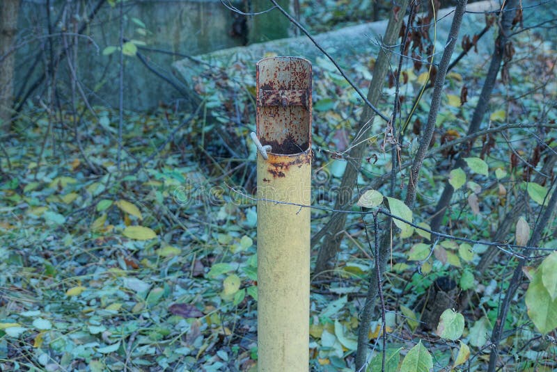 A Long Yellow Iron Pipe Covered with Rust with an Electric Wire Stock ...