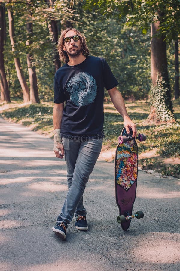 Longboard Skating - a Longboarder Posing beside His Longboard Stock ...