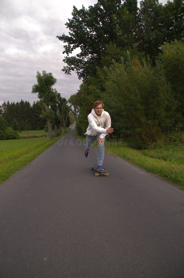 Longboarder Going Up the Hill with Speed, Vertical Stock Photo - Image ...
