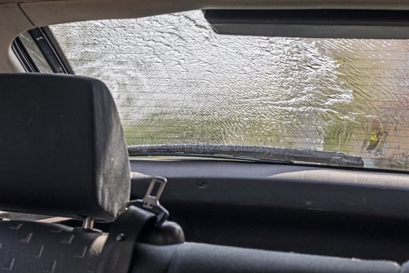 Look through the Blurred Rear Windshield of a Car at a Heavy Downpour ...