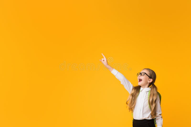 Elementary School Girl Pointing Finger Posing Over Yellow Studio ...