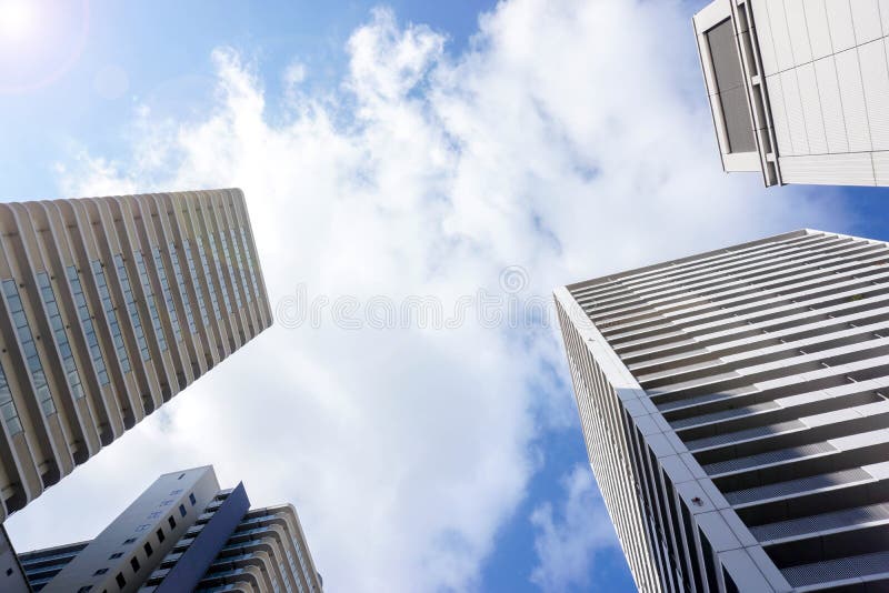 Look Up View and Crop of Office Building on Bright Blue Sky Background ...