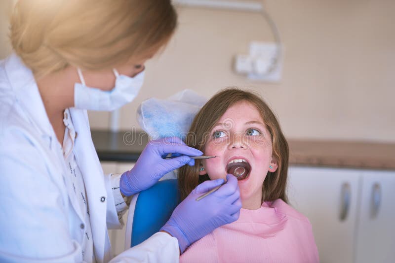 Looking for Any Potential Problems. a Dentist Examining a Little Girls ...